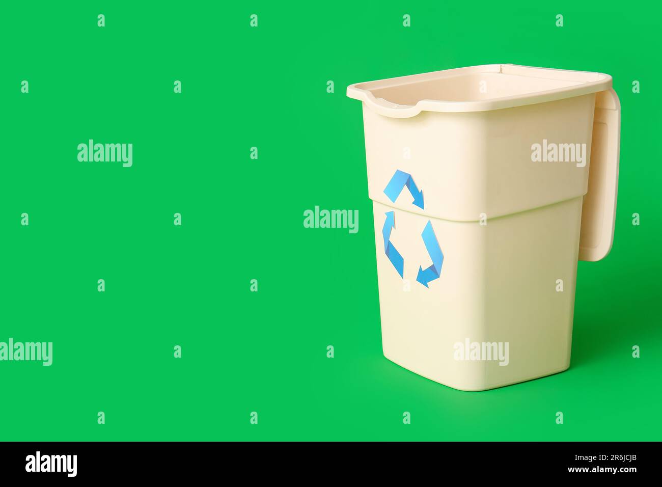 Container for garbage on green background. Recycling concept Stock ...