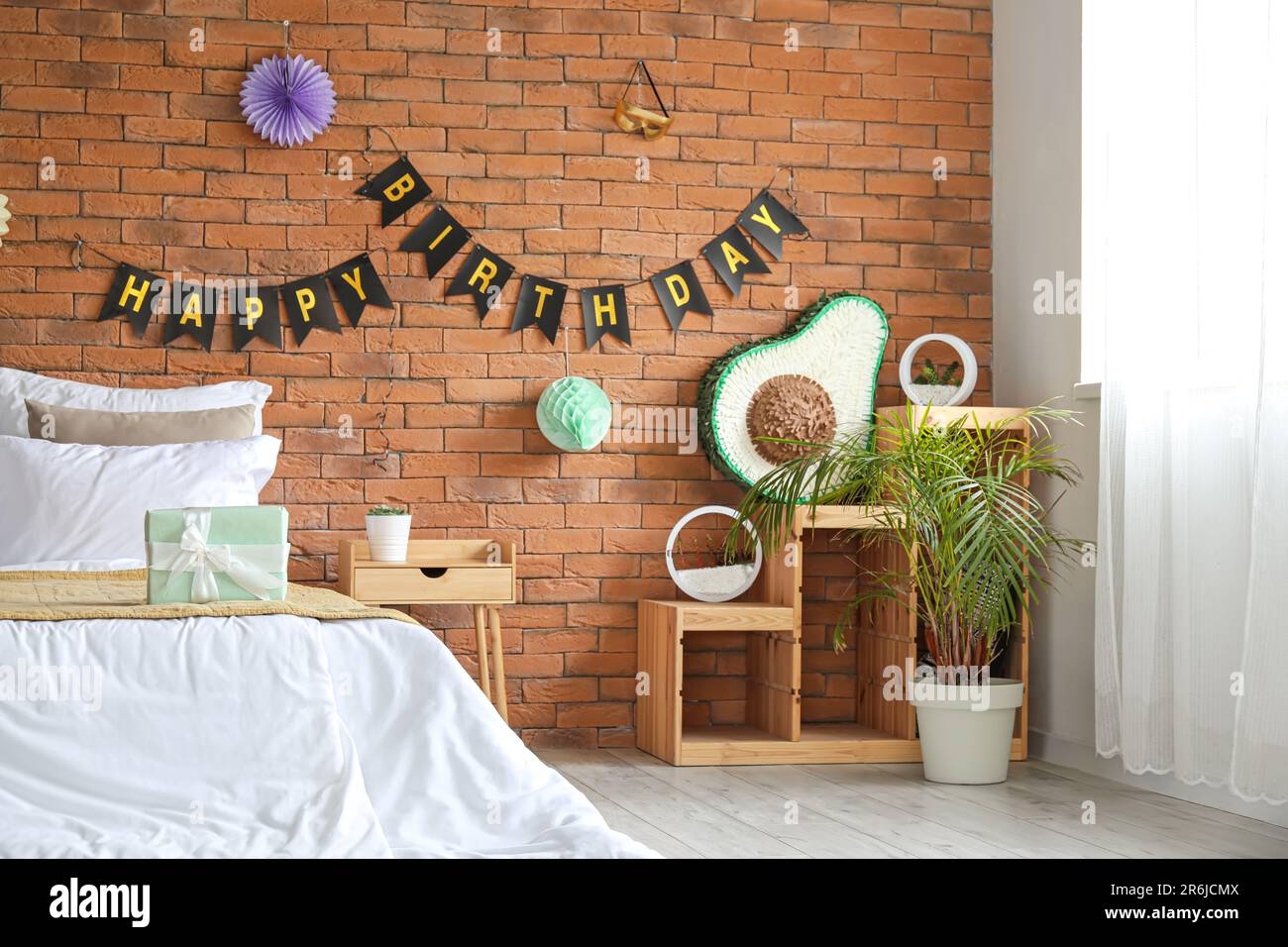 Interior of bedroom decorated for birthday party with pinata, balloons ...