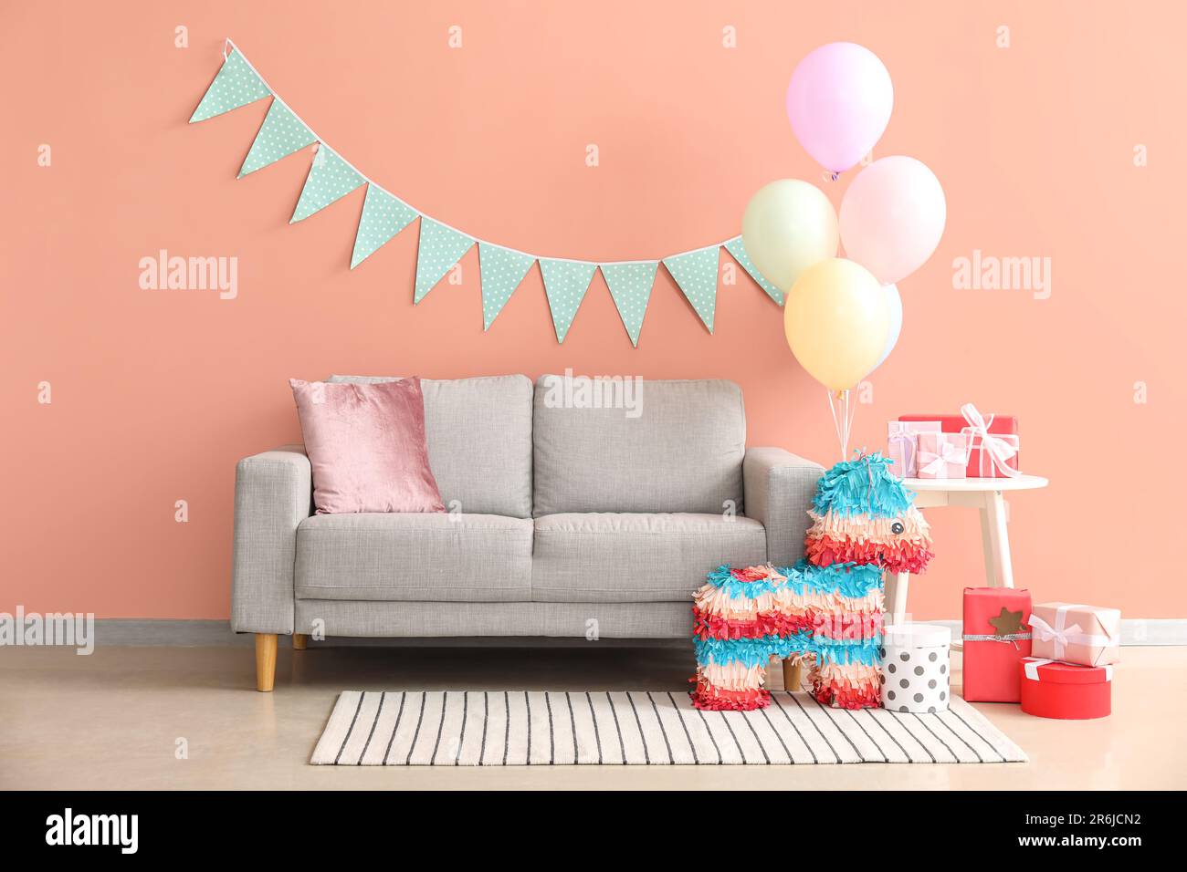 Interior of living room decorated for birthday with balloons, pinata ...