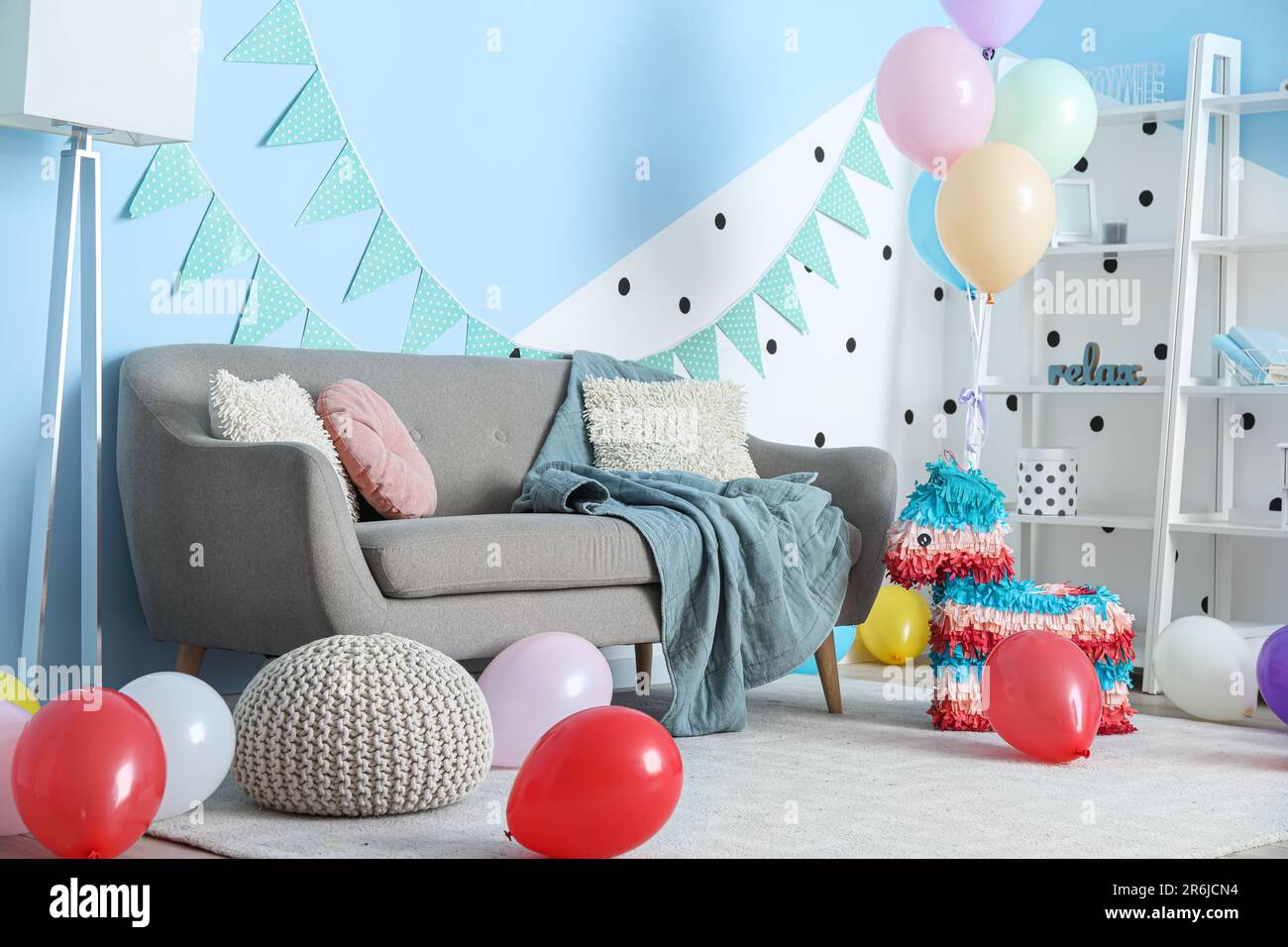 Interior of living room decorated for birthday with balloons, pinata ...