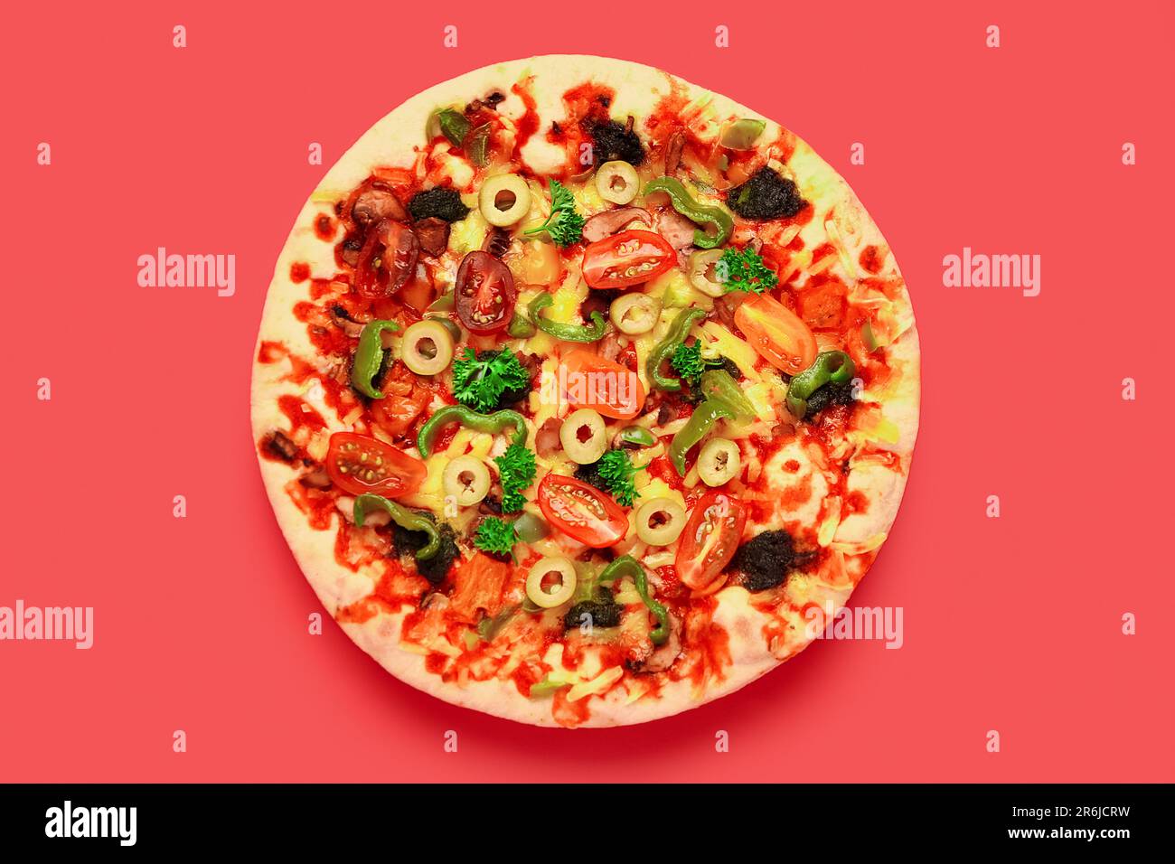 Vegetable pizza on red background Stock Photo - Alamy