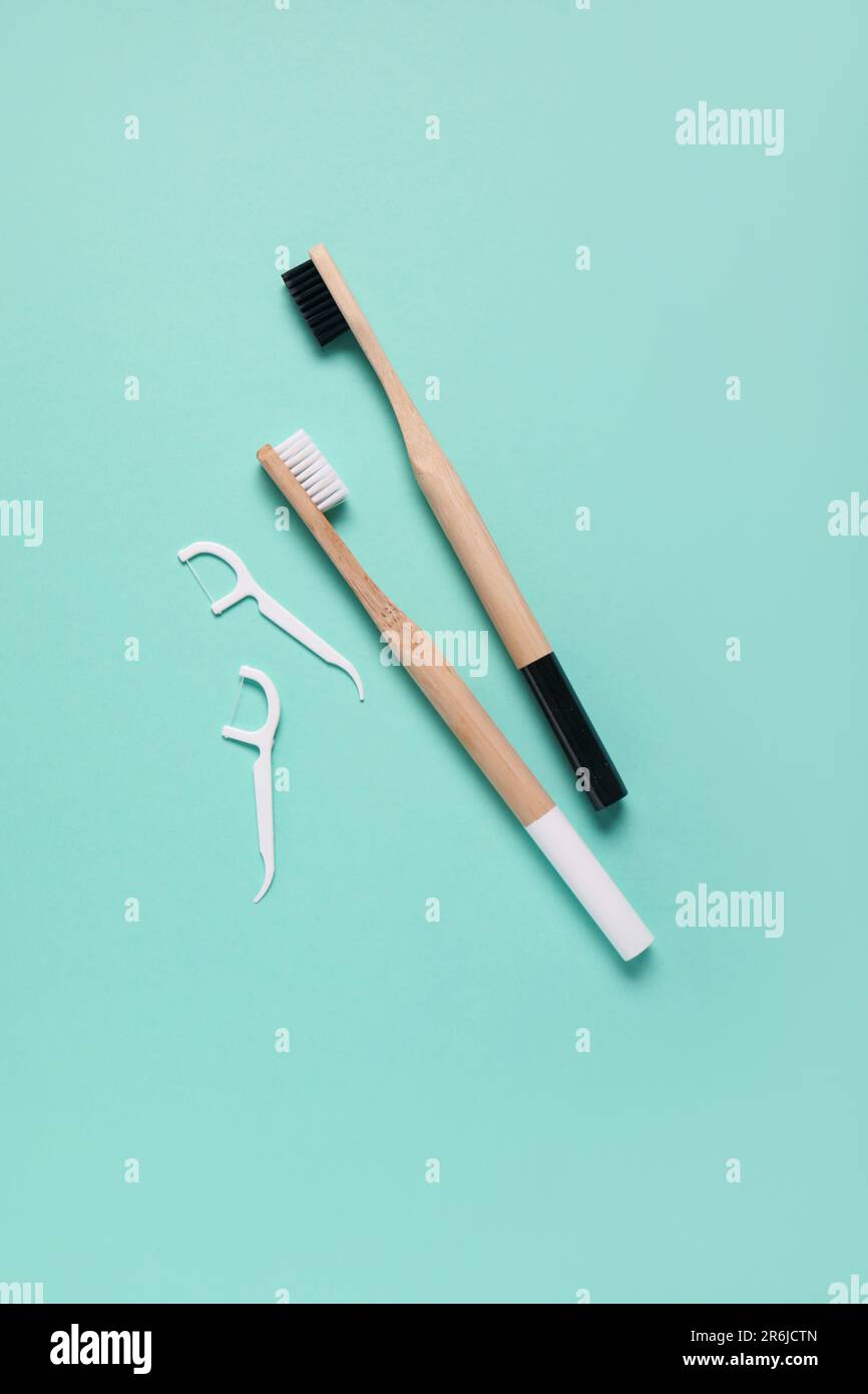 Bamboo toothbrushes and toothpicks on turquoise background Stock Photo ...