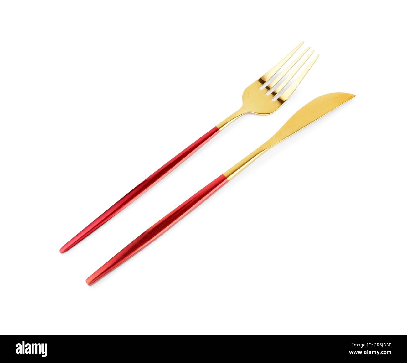Golden fork and knife with red handles on white background Stock Photo ...