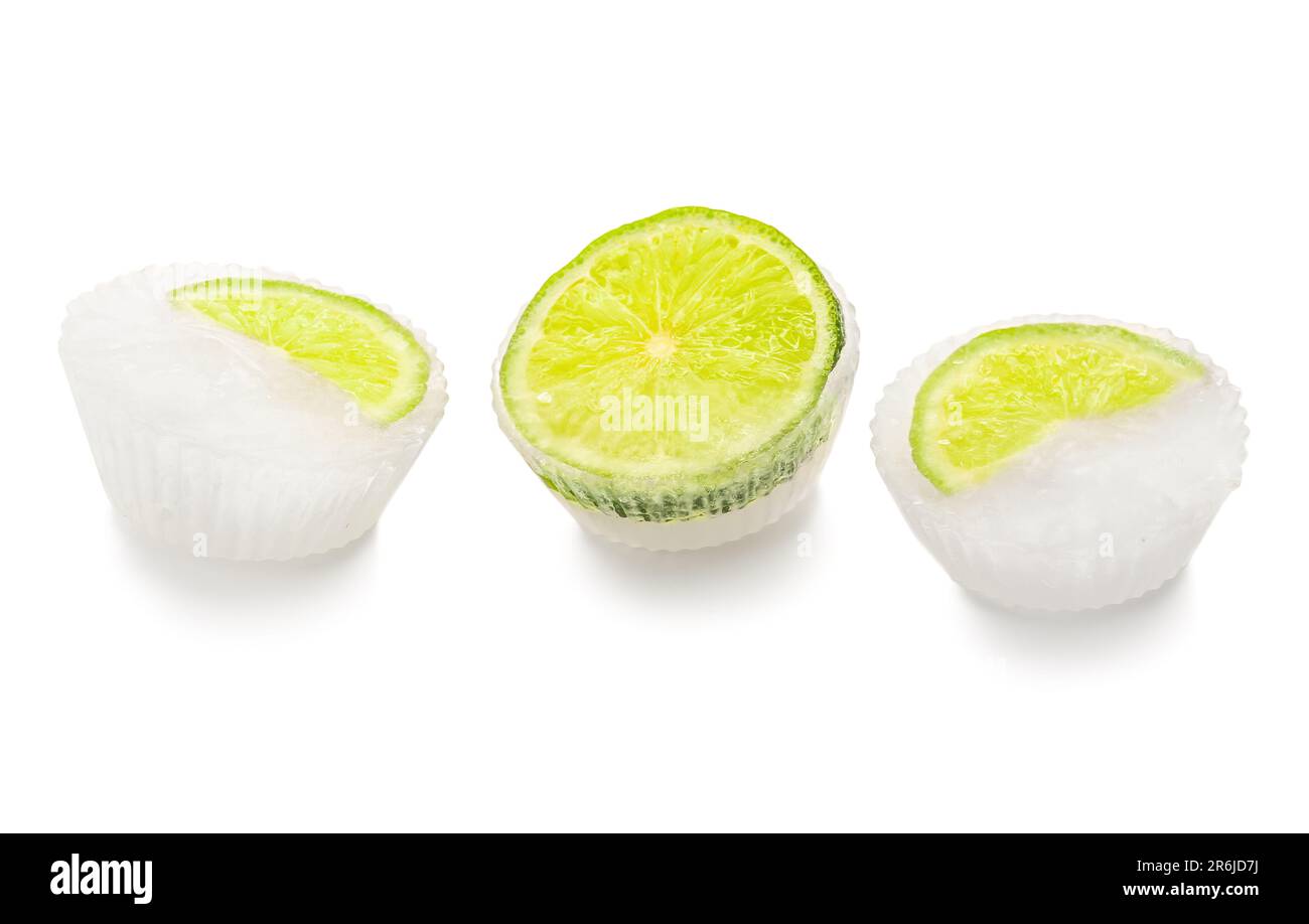 Slices of fresh lime frozen in ice on white background Stock Photo - Alamy