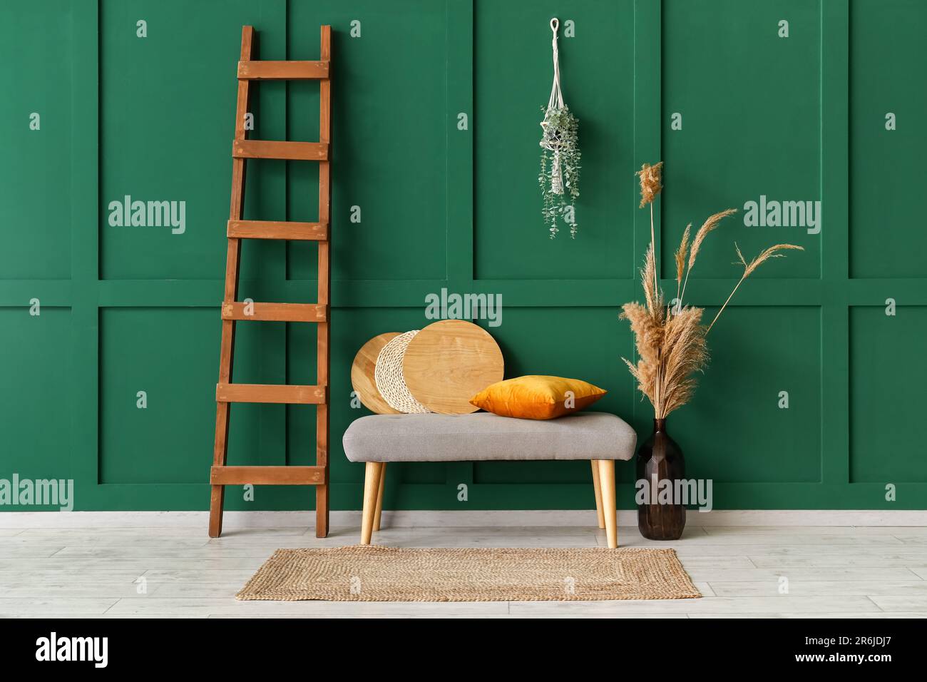 Interior of stylish room with soft bench and ladder Stock Photo - Alamy