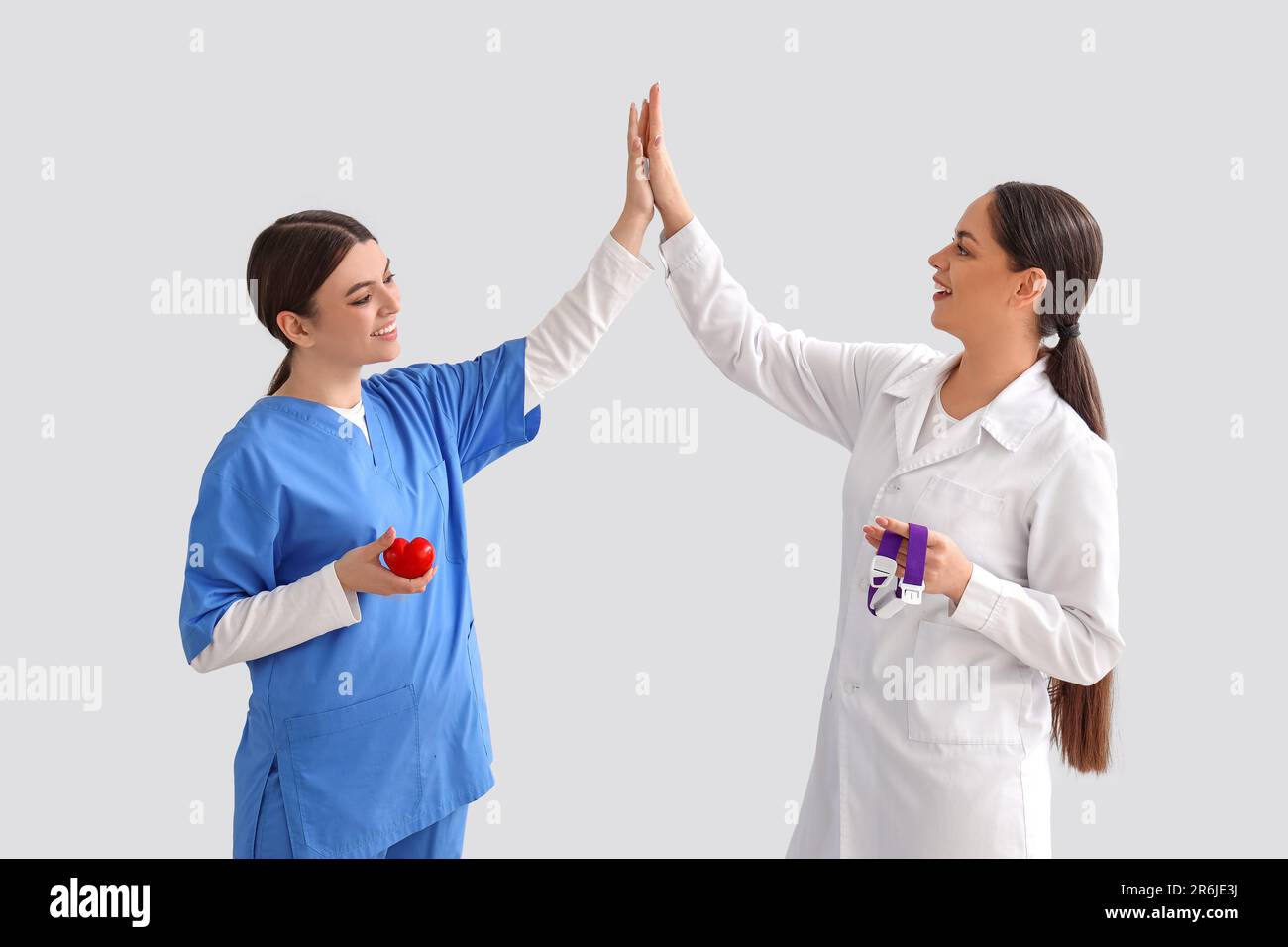 Female nurse and doctor with belt for blood transfusion giving each ...