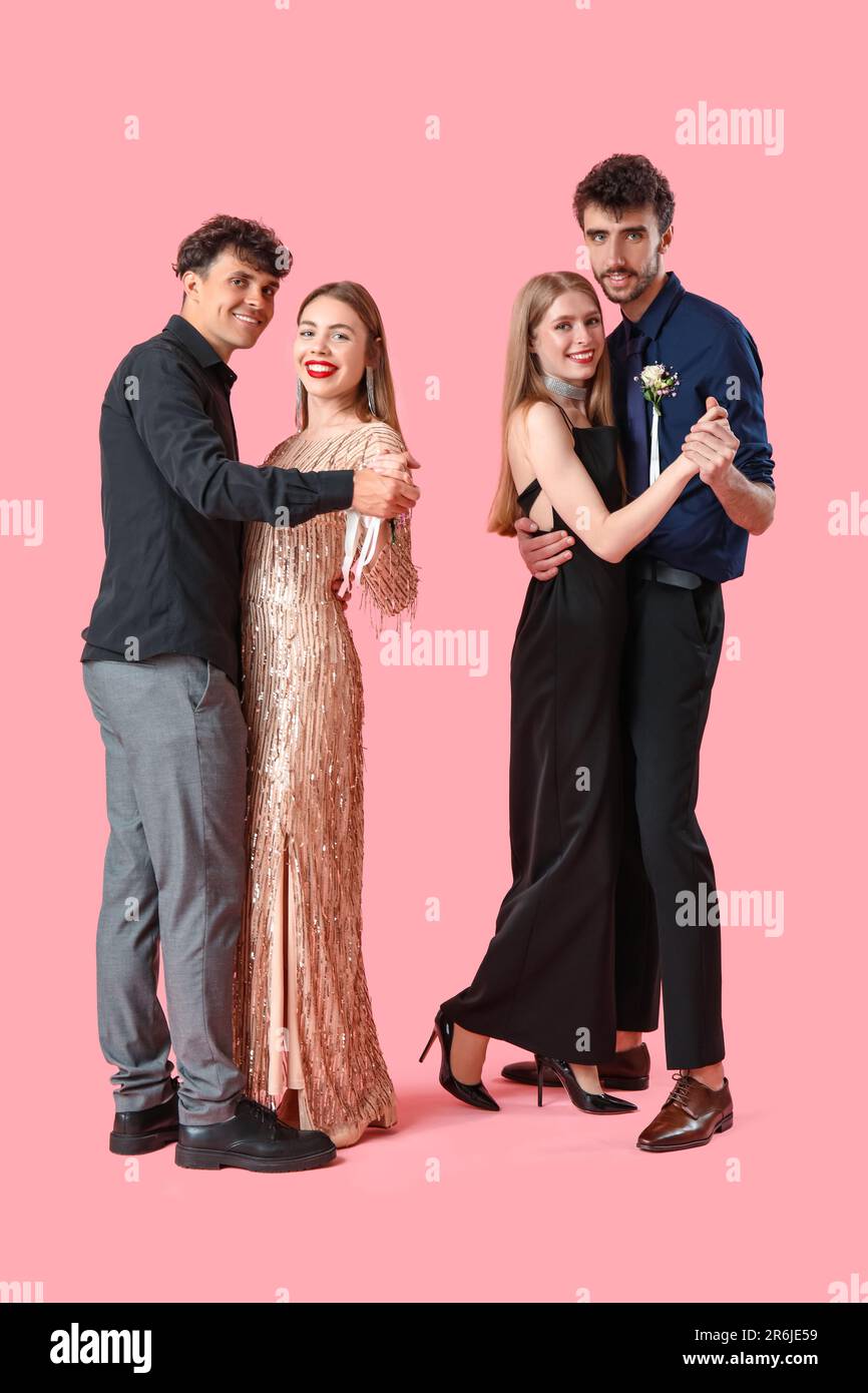Beautiful prom couples dancing on pink background Stock Photo - Alamy