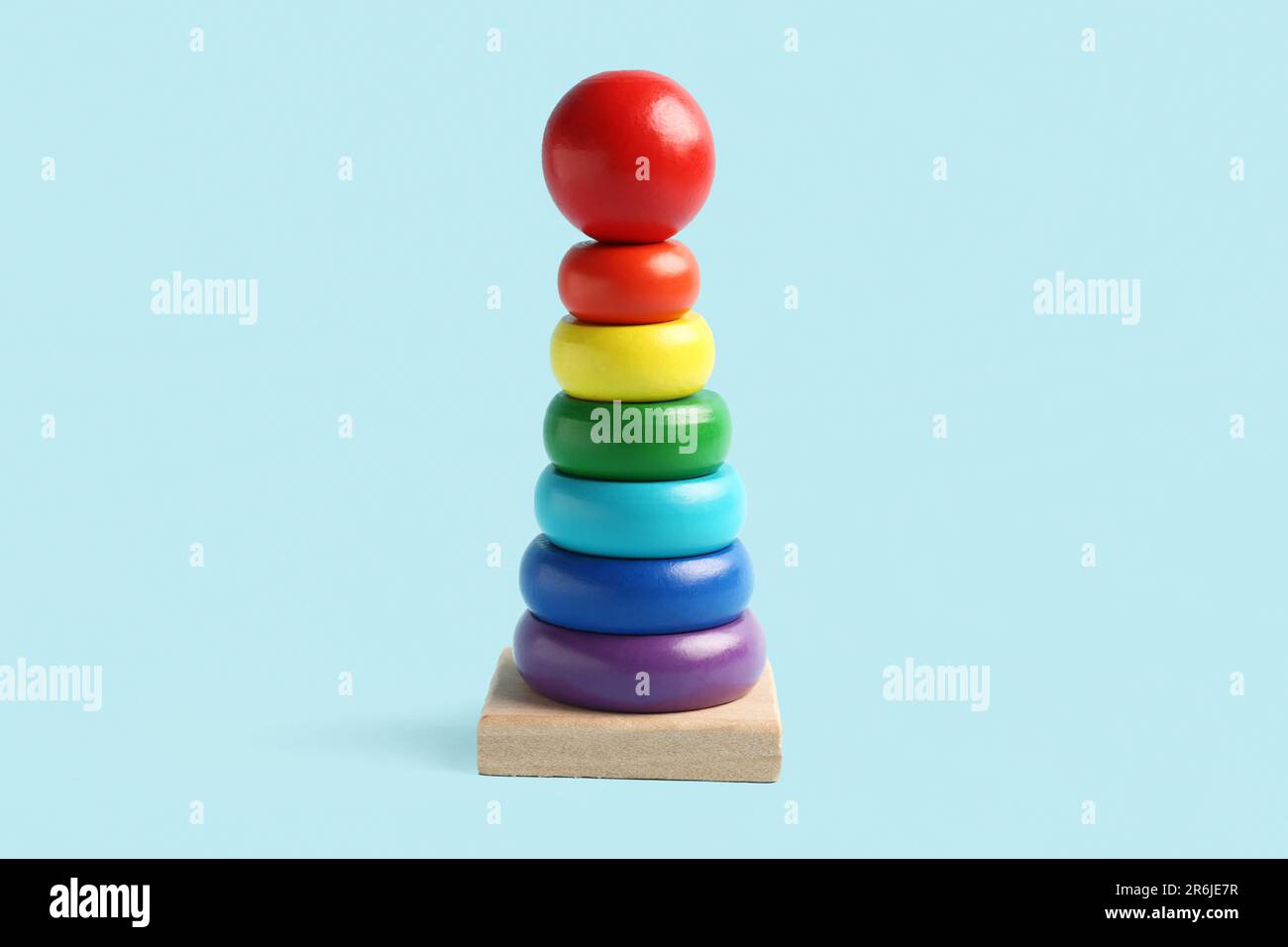 Wooden colorful toy pyramid on blue background. Children's Day ...