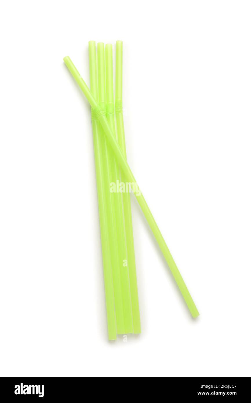 Green plastic straws on white background Stock Photo - Alamy