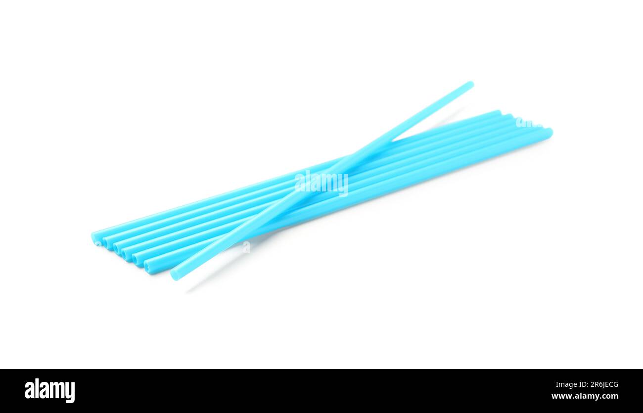 Blue plastic straws on white background Stock Photo - Alamy