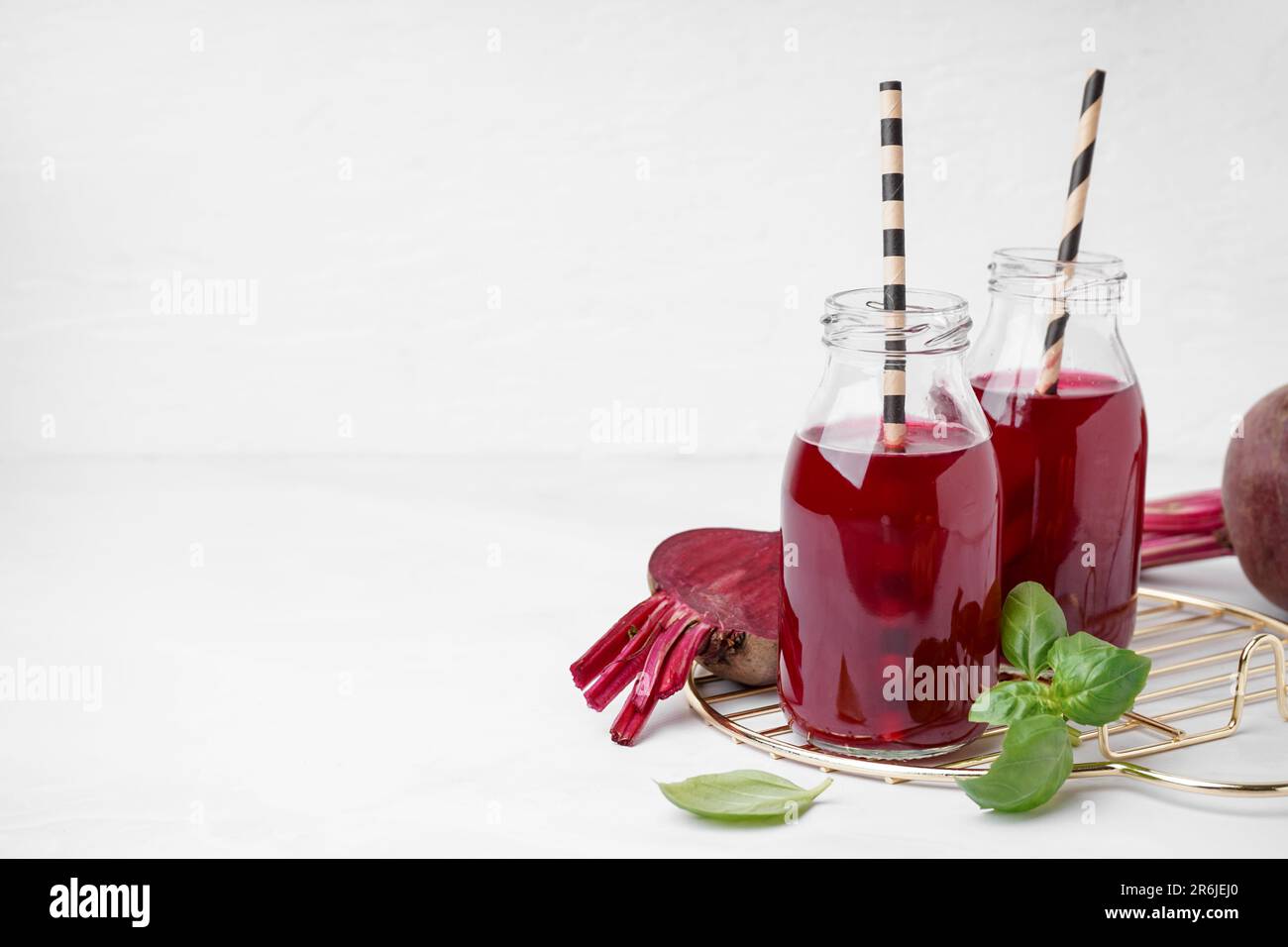 Bottles of fresh beetroot juice on white background Stock Photo - Alamy