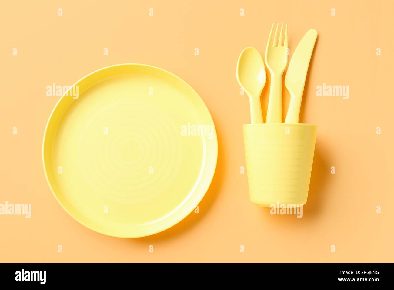 Different eating utensils for baby on pale orange background Stock ...