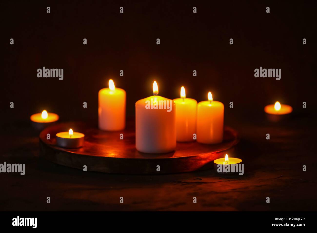 Beautiful burning candles on black background Stock Photo - Alamy