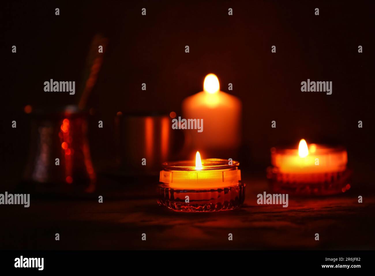 Beautiful burning candles on black background Stock Photo - Alamy