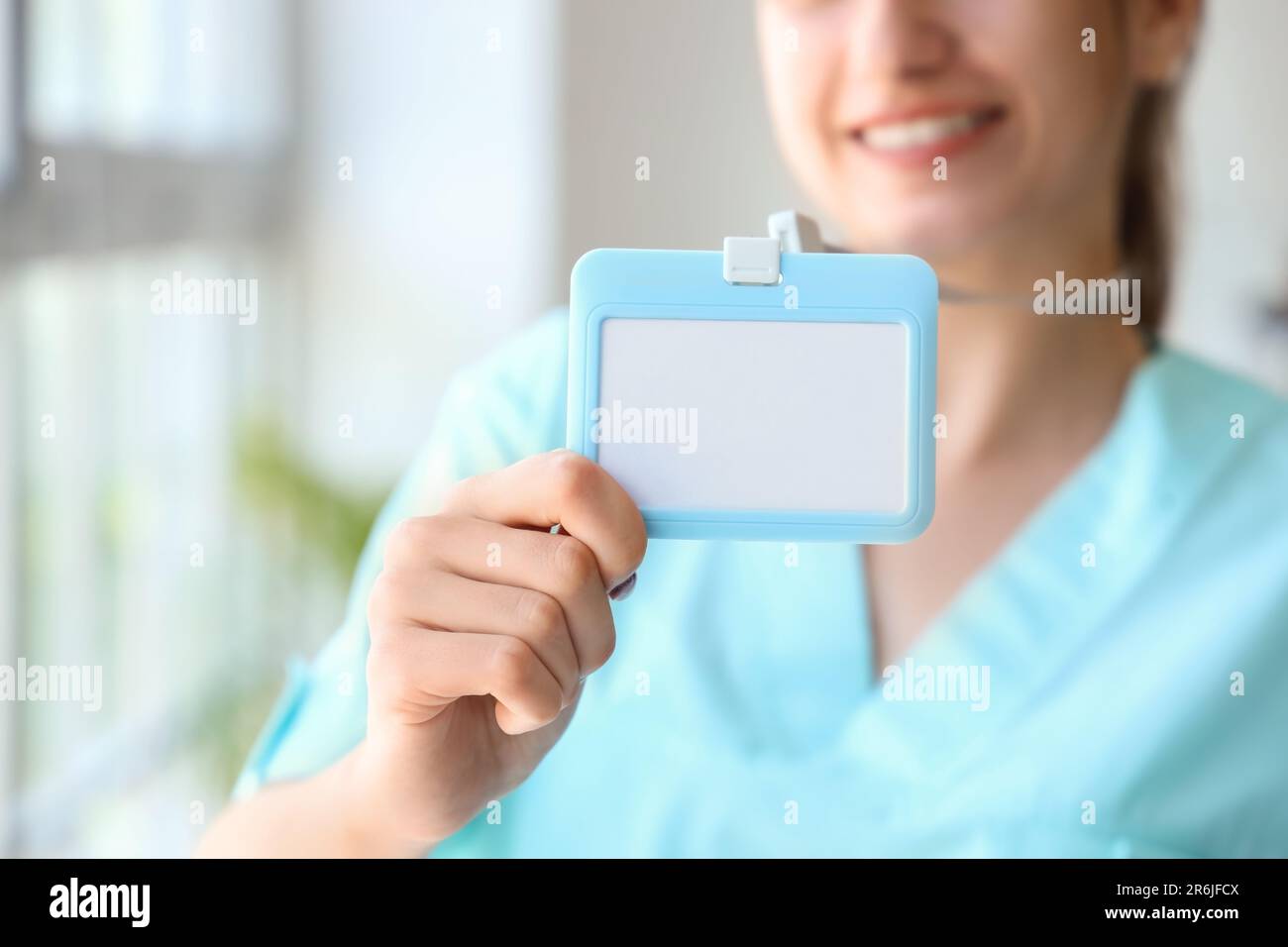 Female medical intern with badge at hospital, closeup Stock Photo - Alamy