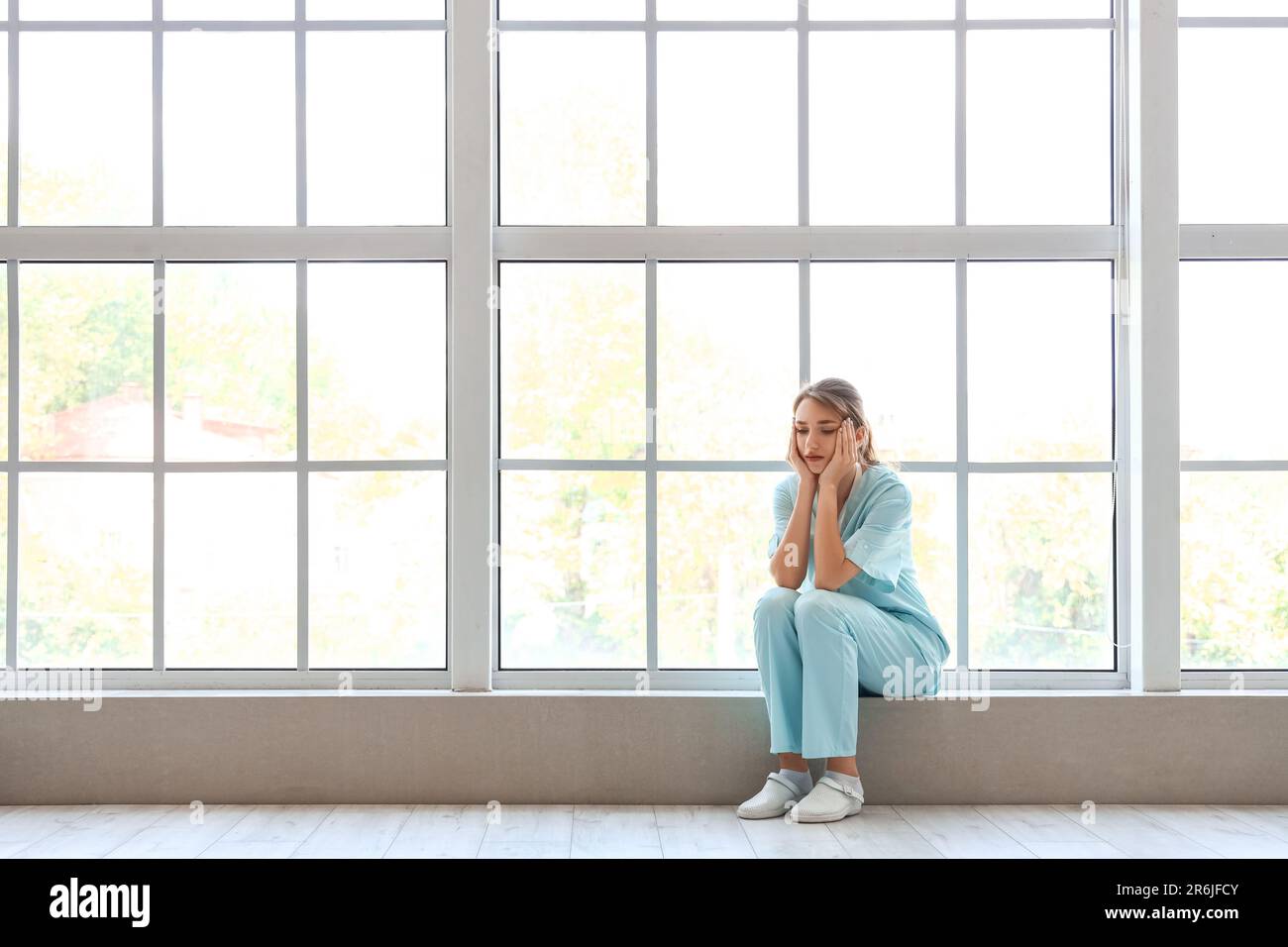 Stressed female medical intern at hospital Stock Photo - Alamy