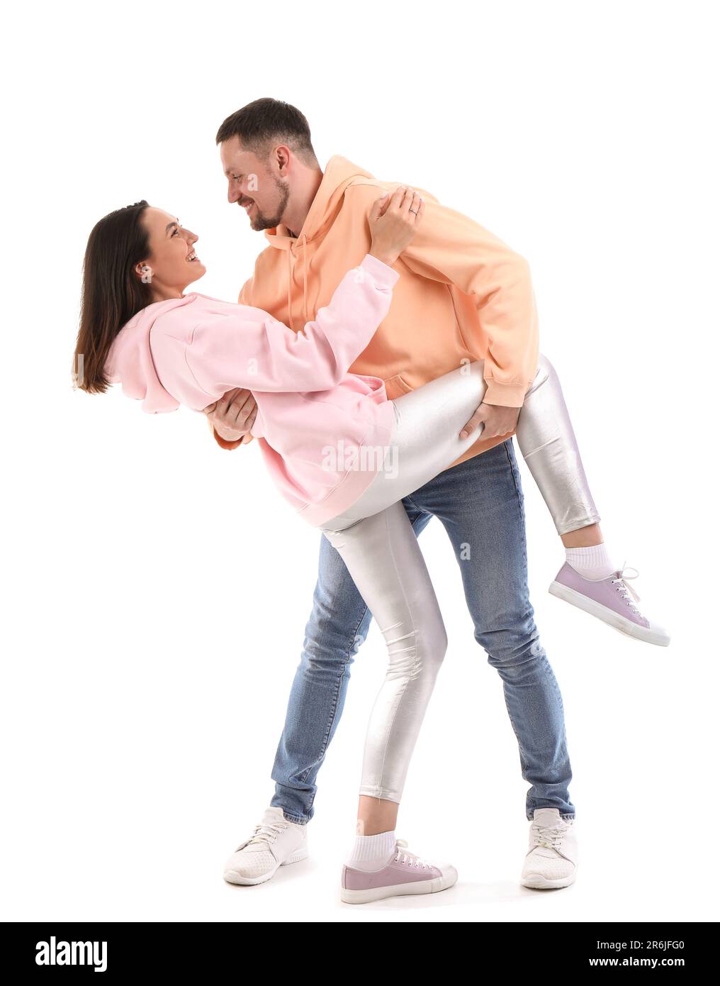 Happy engaged couple dancing on white background Stock Photo - Alamy