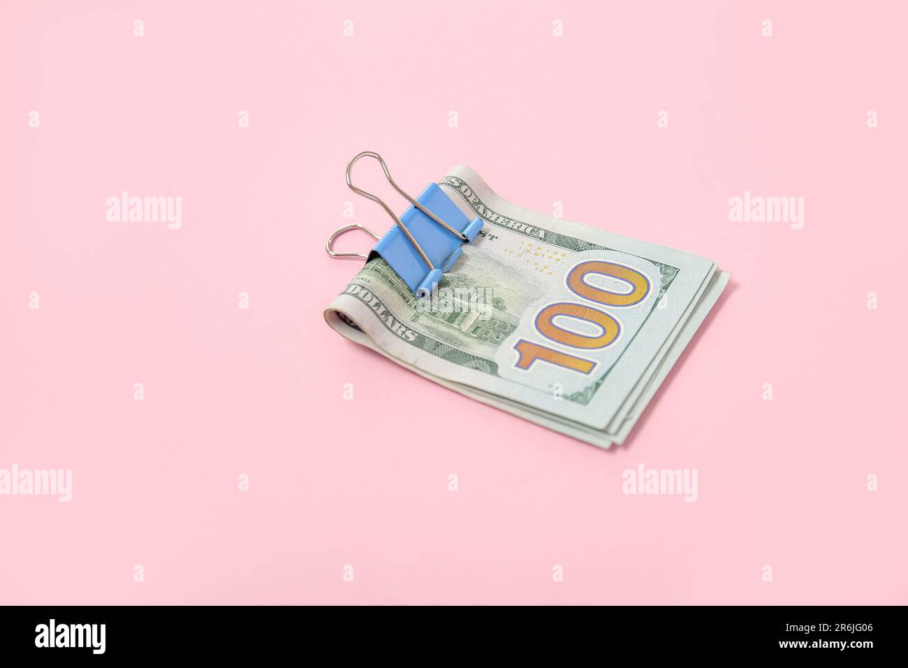 One hundred dollar banknotes with binder clip on pink background Stock ...