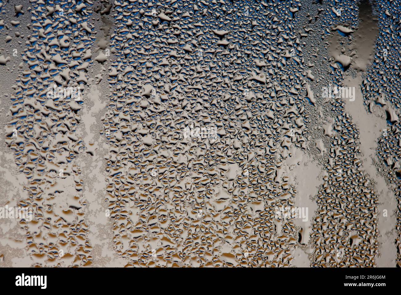 Heavy rain and condensation on a window, the colours are from out of ...