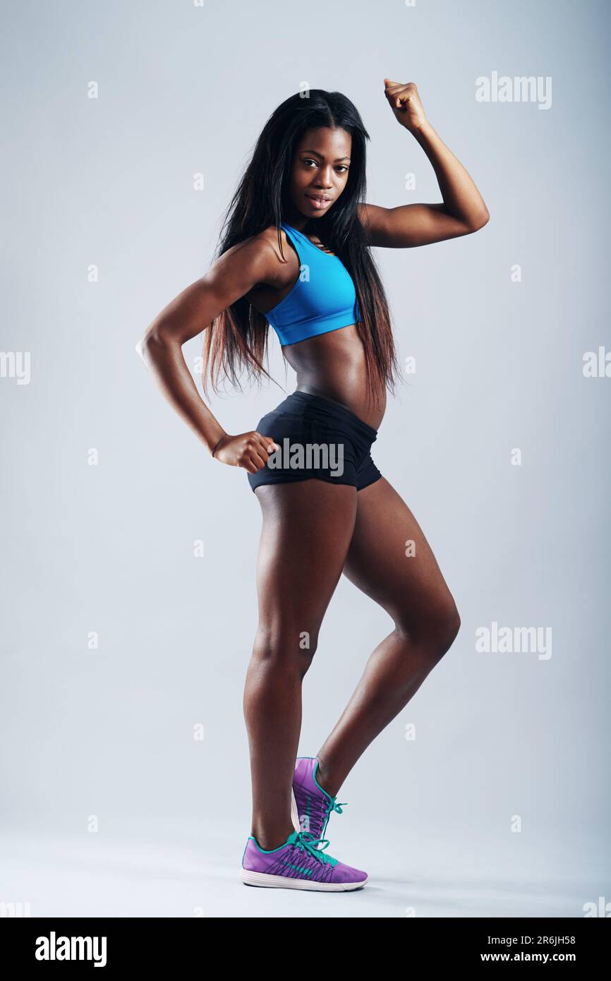 Black woman, studio and flex with strong arm, confidence and body wellness by white background ...