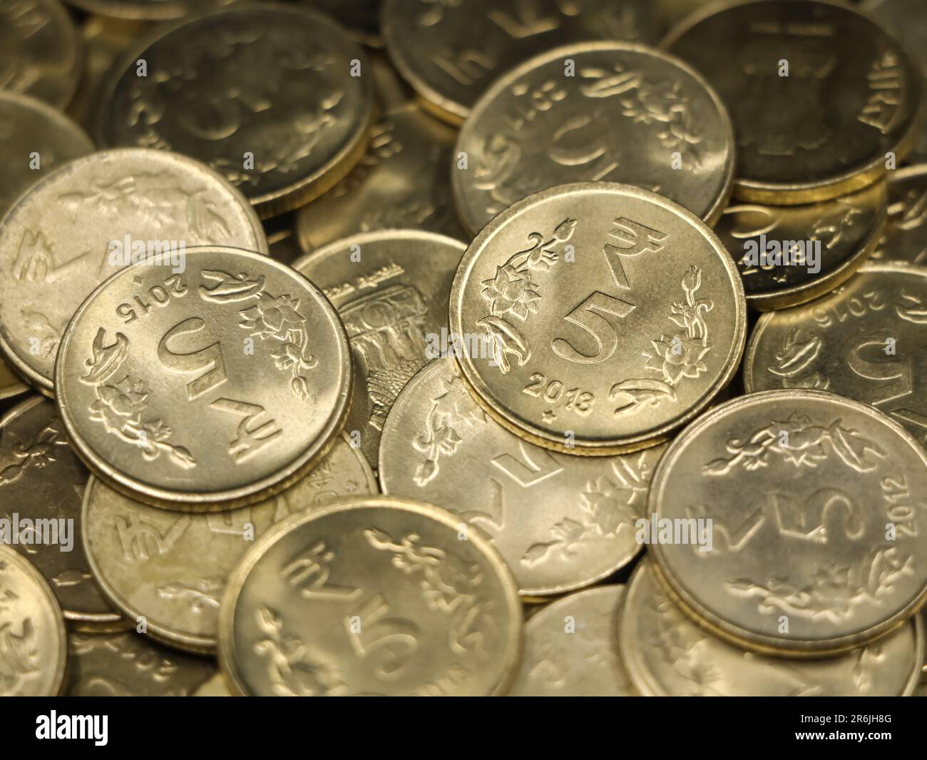 closeup shot of a collection of vintage golden 5 or five rupees in a ...