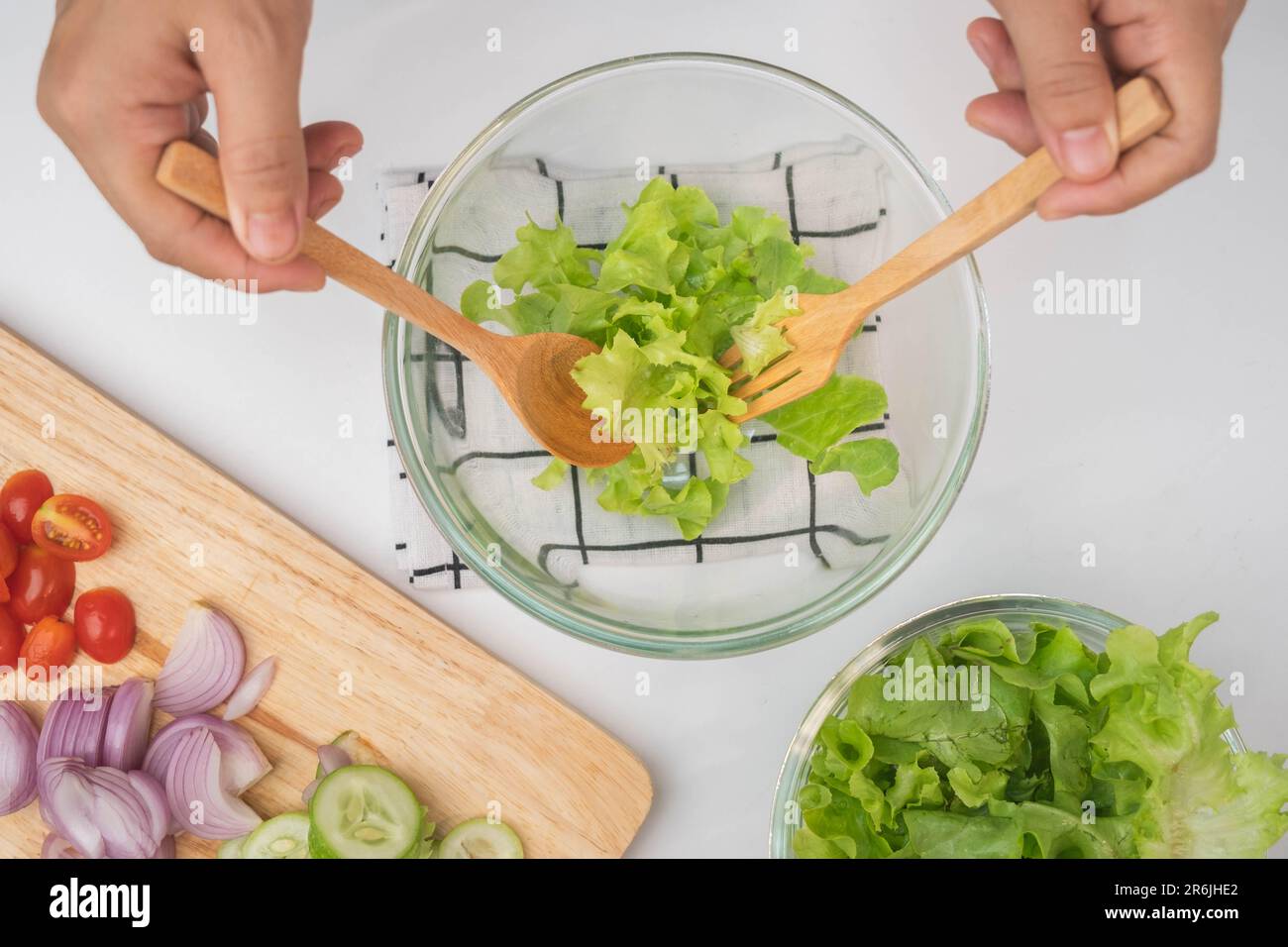 Cooking - Woman making fresh organic vegetable salad in the kitchen ...