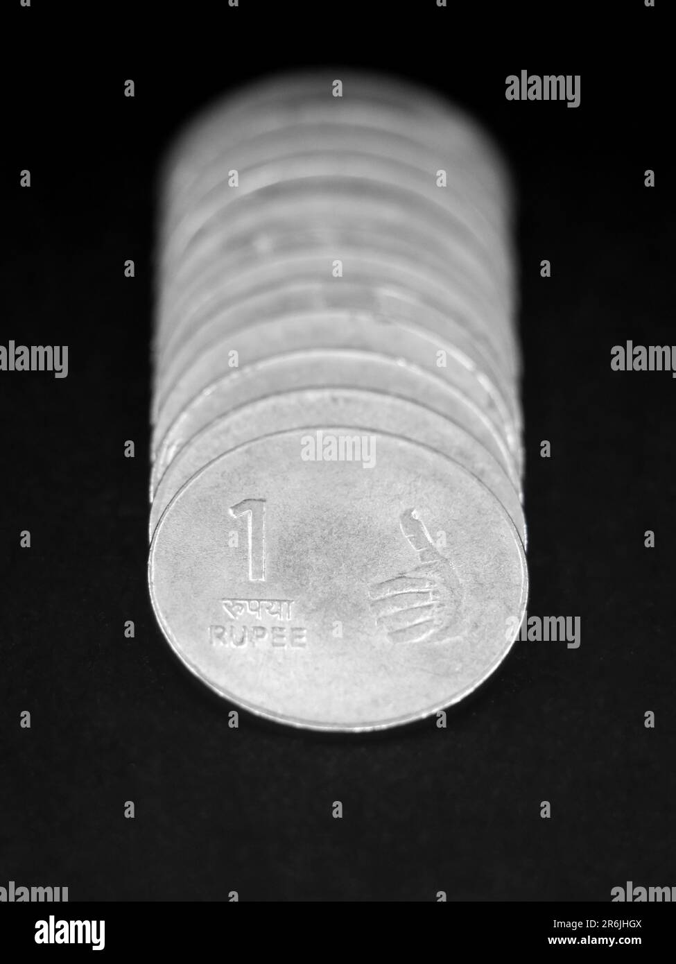 closeup of rare vintage indian 1 rupee coin in silver arranged in a row ...