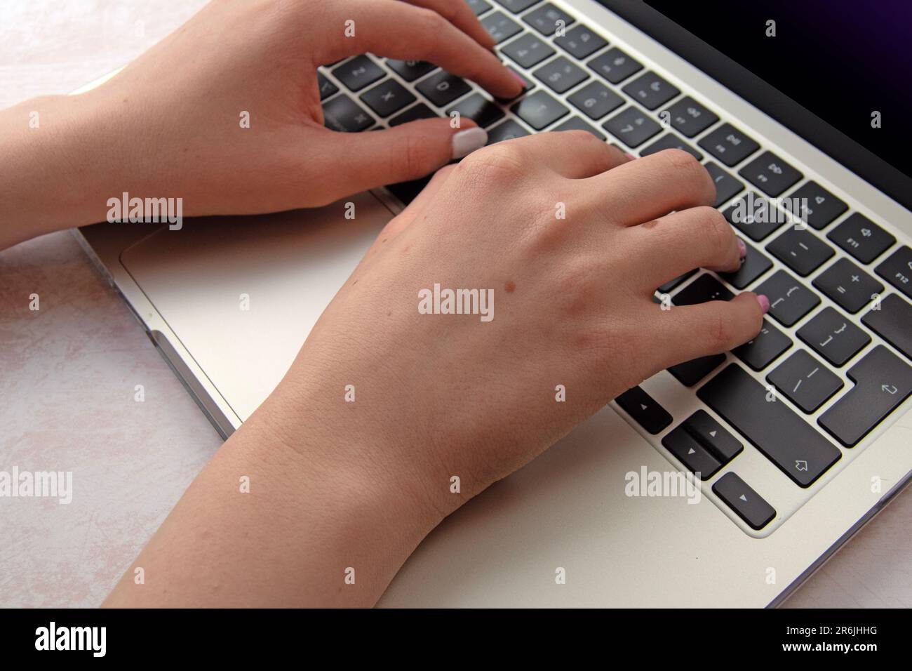 Girls hands on laptop keyboard with marble background Stock Photo - Alamy
