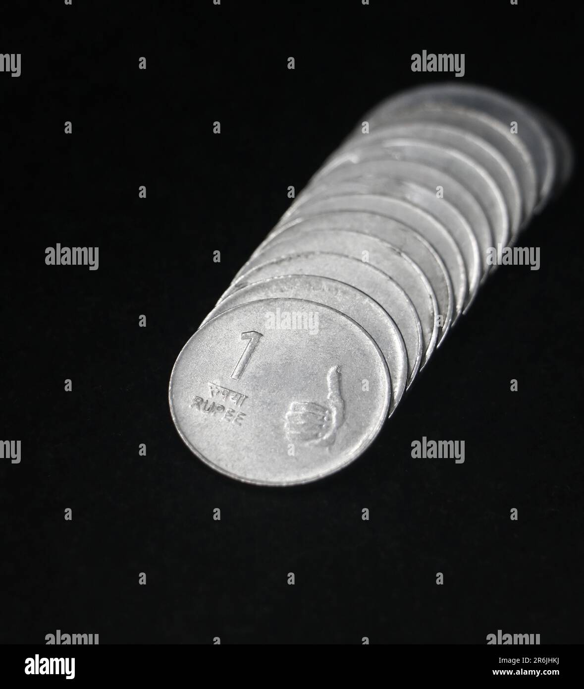 closeup of rare vintage indian 1 rupee coin in silver arranged in a row ...