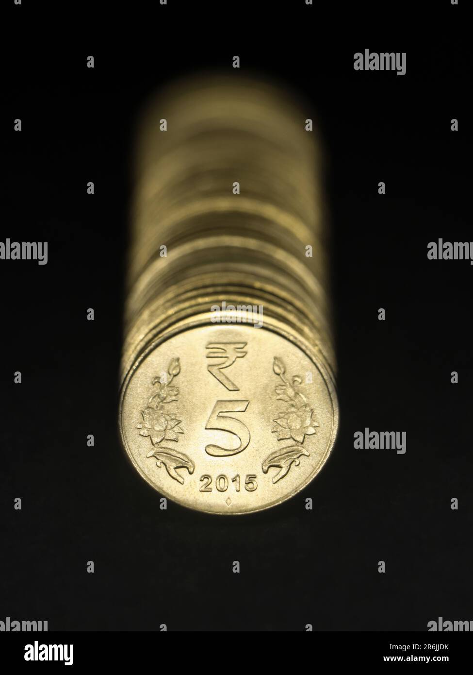 closeup of vintage 5 or five rupee gold coins of india arranged in a ...