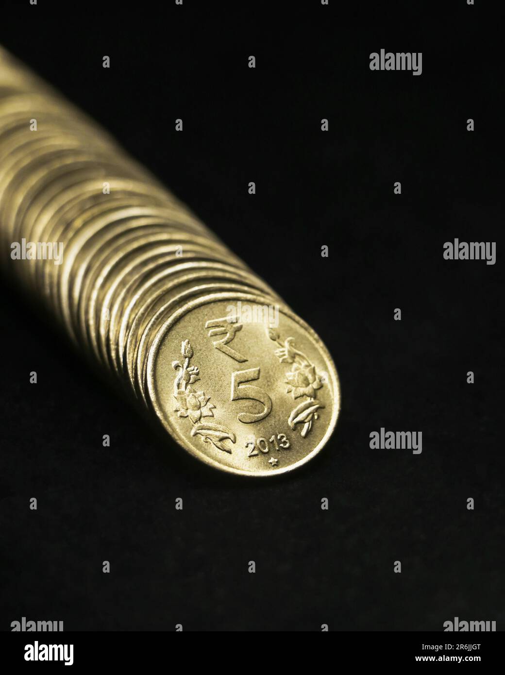 closeup of vintage 5 or five rupee gold coins of india arranged in a ...
