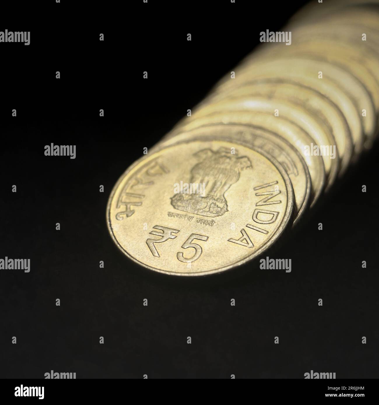 closeup of vintage 5 or five rupee gold coins of india arranged in a ...