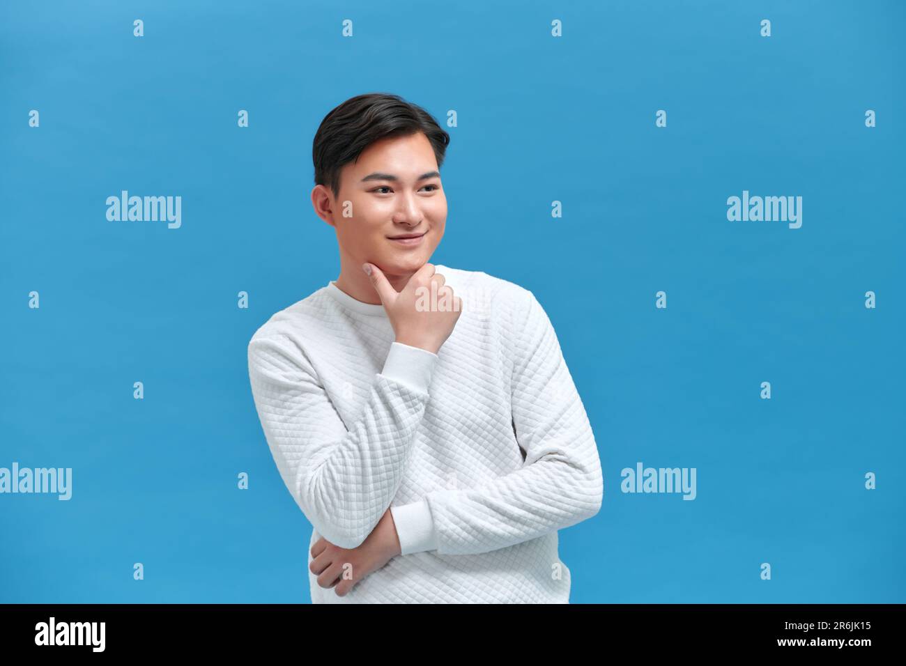 Smiling Young Attractive Man Touching Chin Stock Photo - Alamy