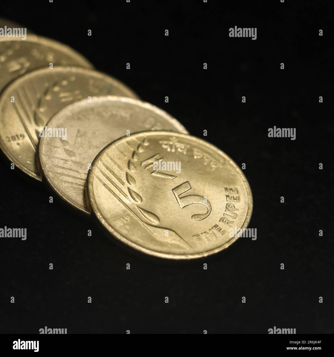 closeup of vintage 5 or five rupee gold coins of india arranged in a ...