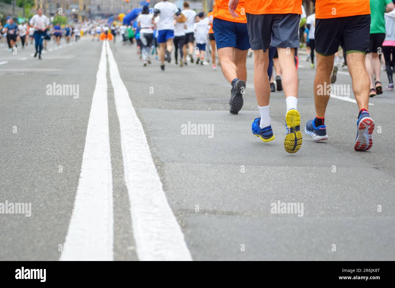 Marathon running race, many runners feet on road racing, sport ...