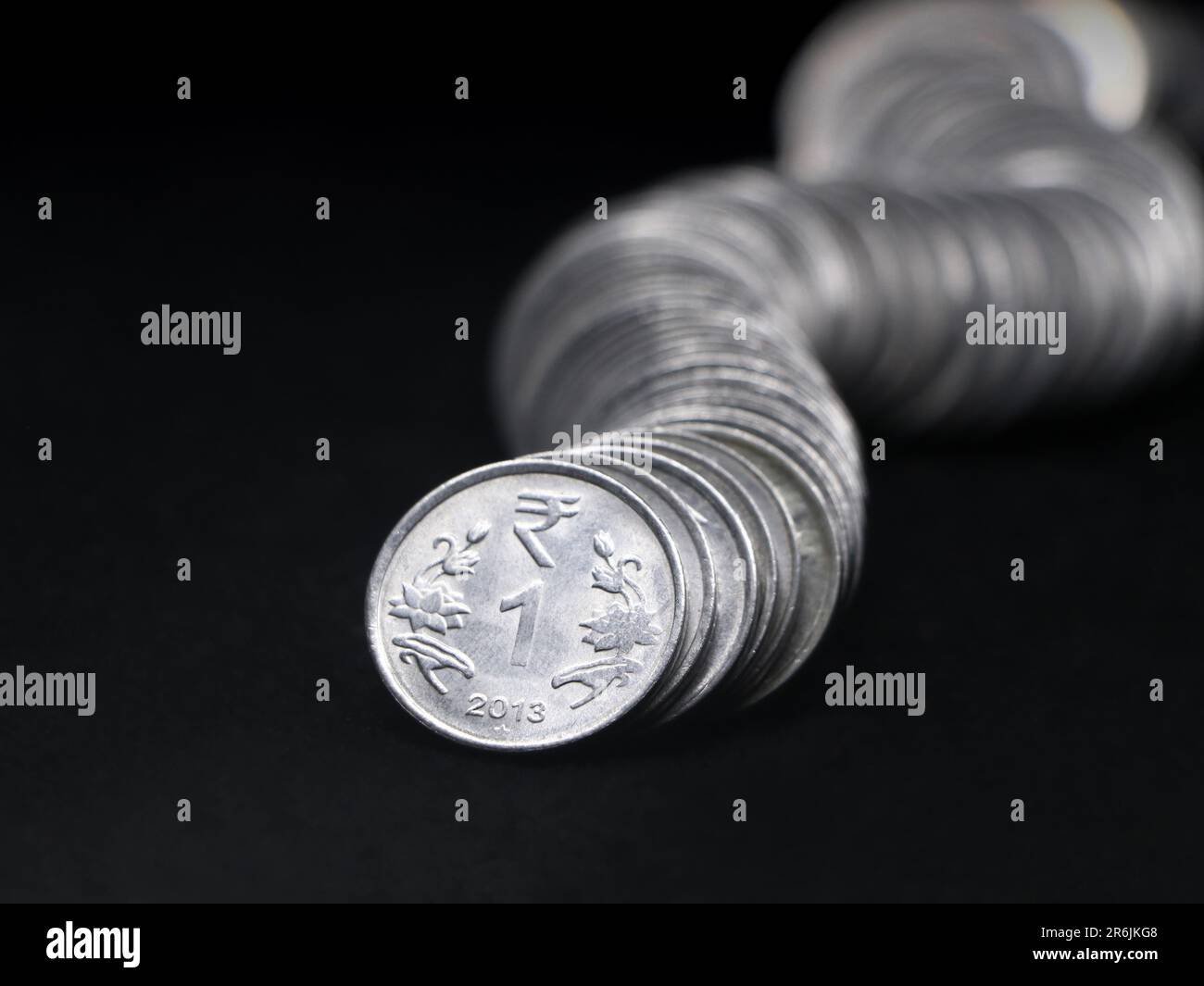 1 (one) rupee coins of india made of silver stacked together in a ...