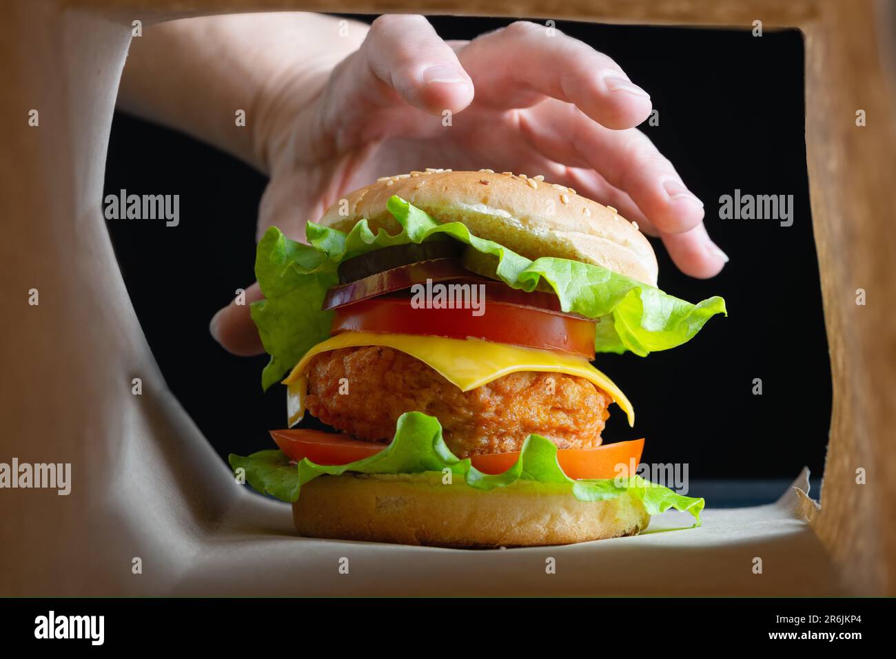 Chicken burger in paper bag package.Fast food for breakfast.Junk food ...