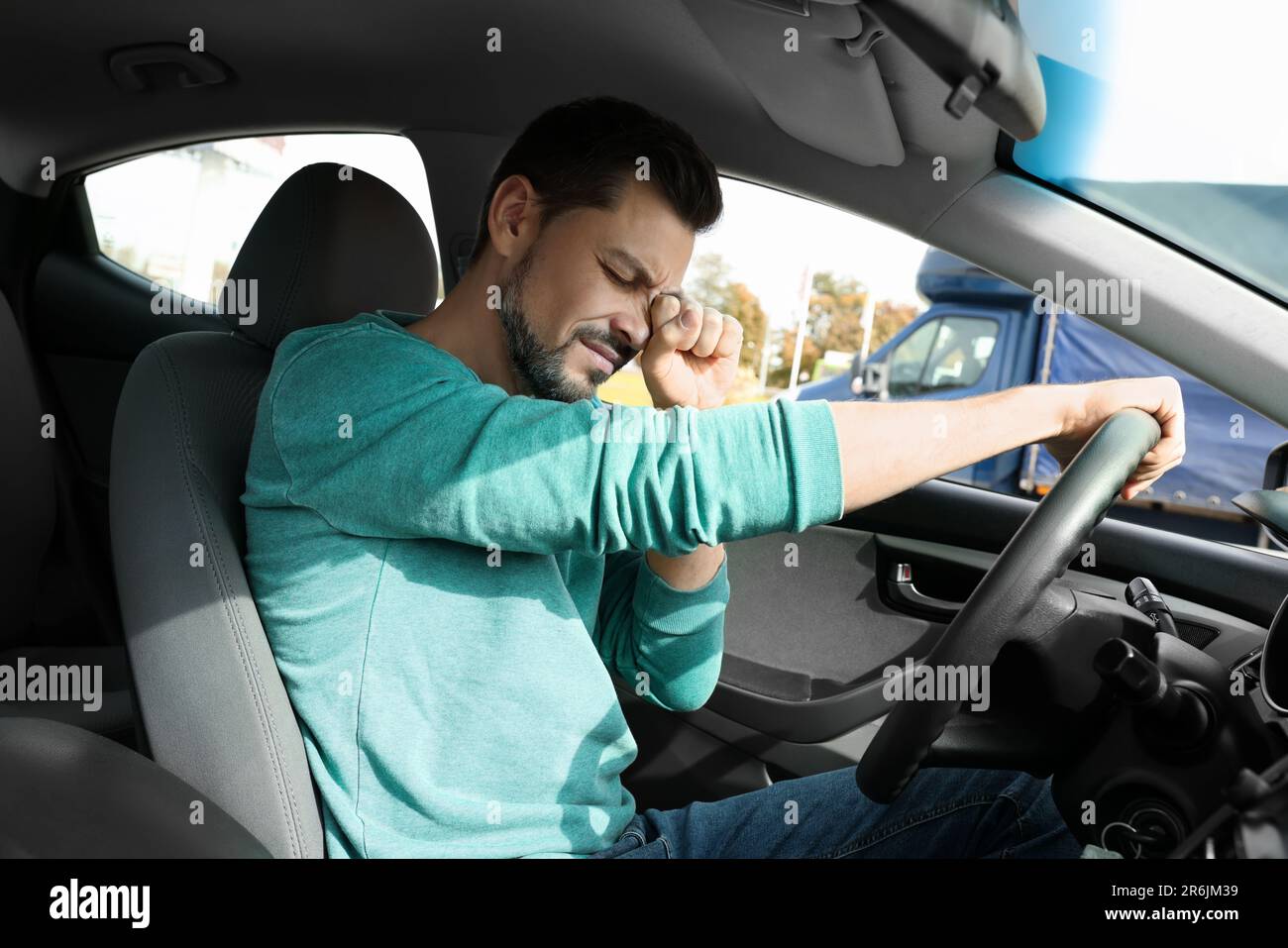 Sleepy tired man in his modern car Stock Photo - Alamy