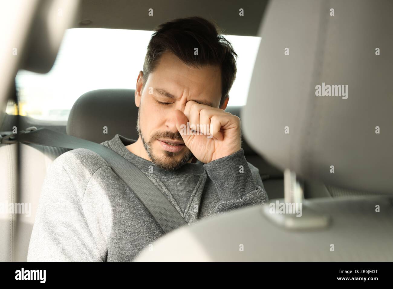 Sleepy tired man sitting in modern car Stock Photo - Alamy