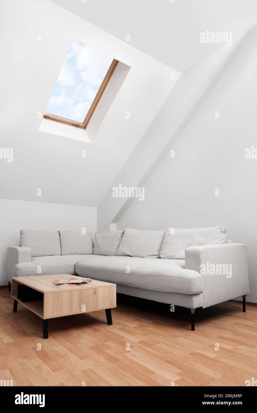 Attic room interior with slanted ceiling and furniture Stock Photo - Alamy
