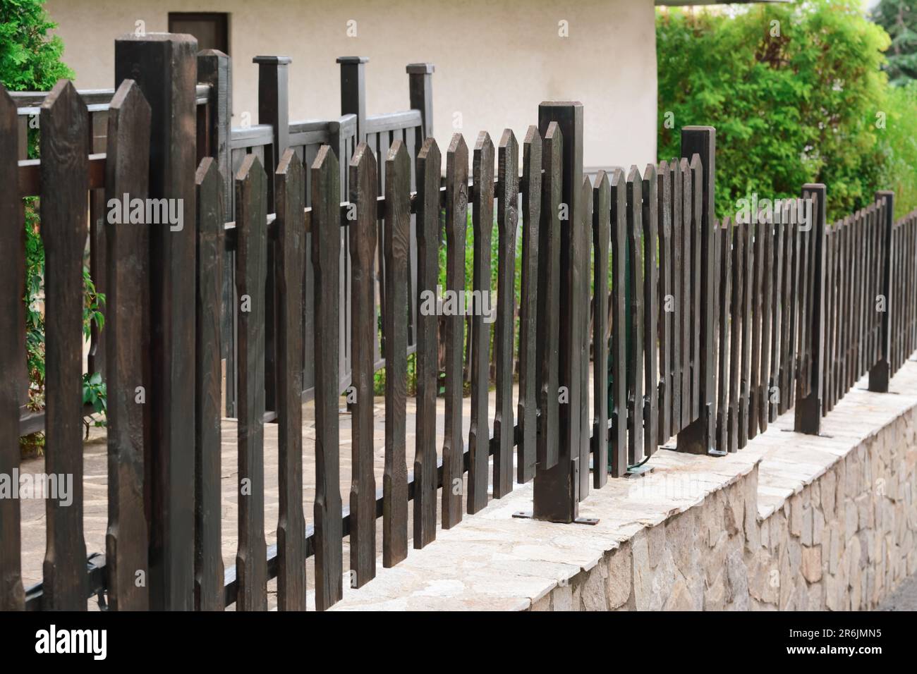 Low wooden shabby fence near building outdoors Stock Photo - Alamy