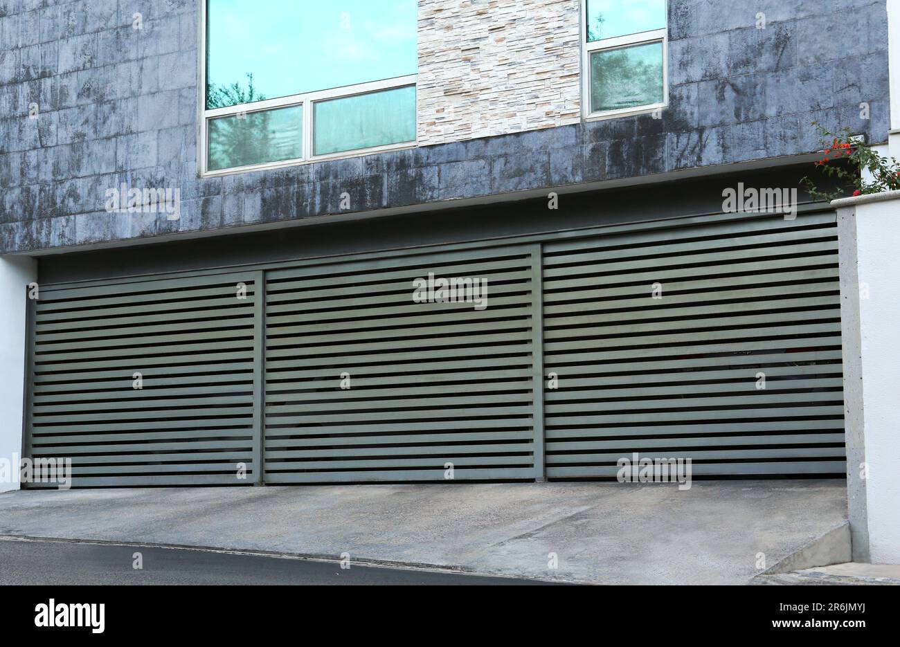 Closed roller shutter gates of modern garage Stock Photo - Alamy