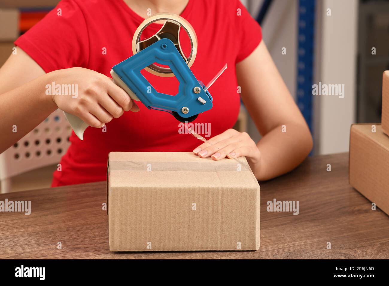 Post office worker packing parcel at counter indoors, closeup Stock ...