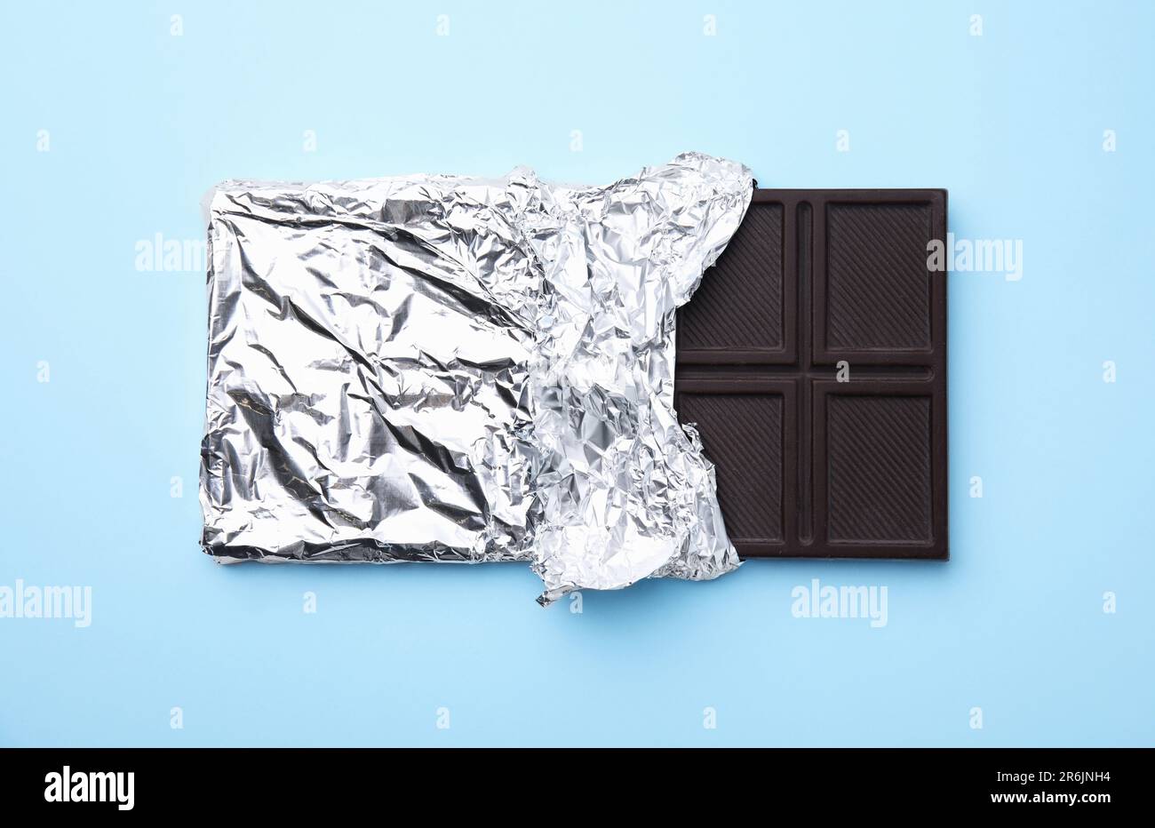 Tasty chocolate bar on light blue background, top view Stock Photo - Alamy