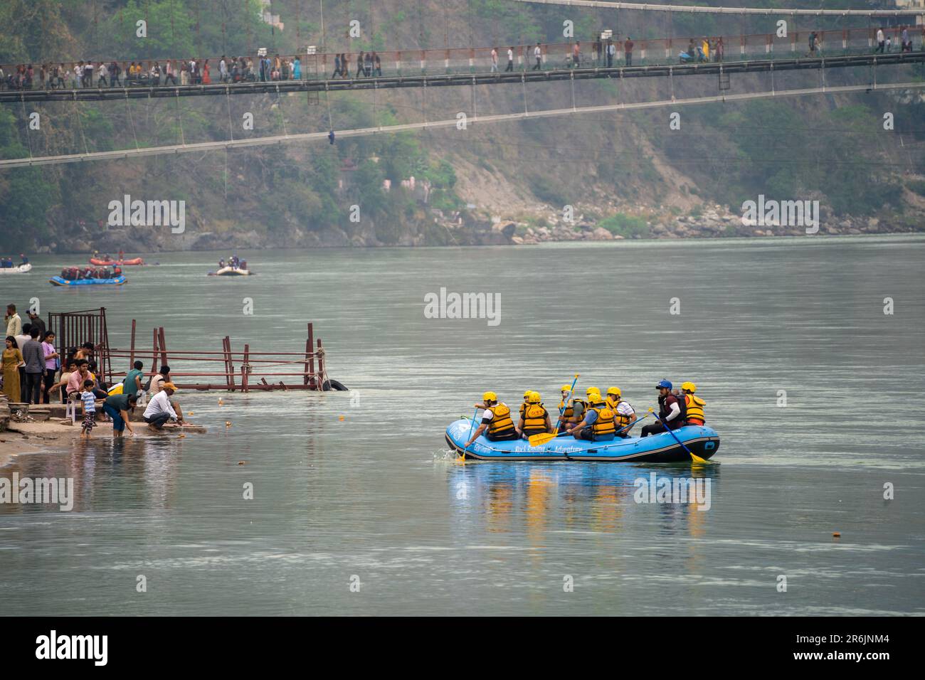 family friends in white water raft in front of temples ghats and the ...