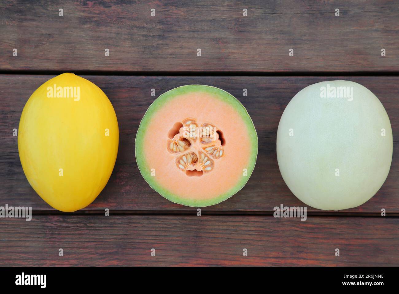 Different types of tasty ripe melons on wooden table, flat lay Stock ...