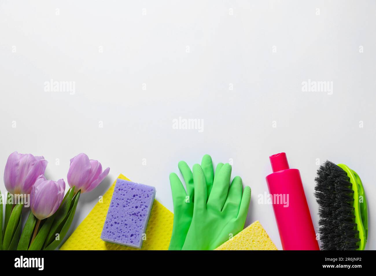 Spring cleaning. Detergent, flowers and tools on white background, flat ...