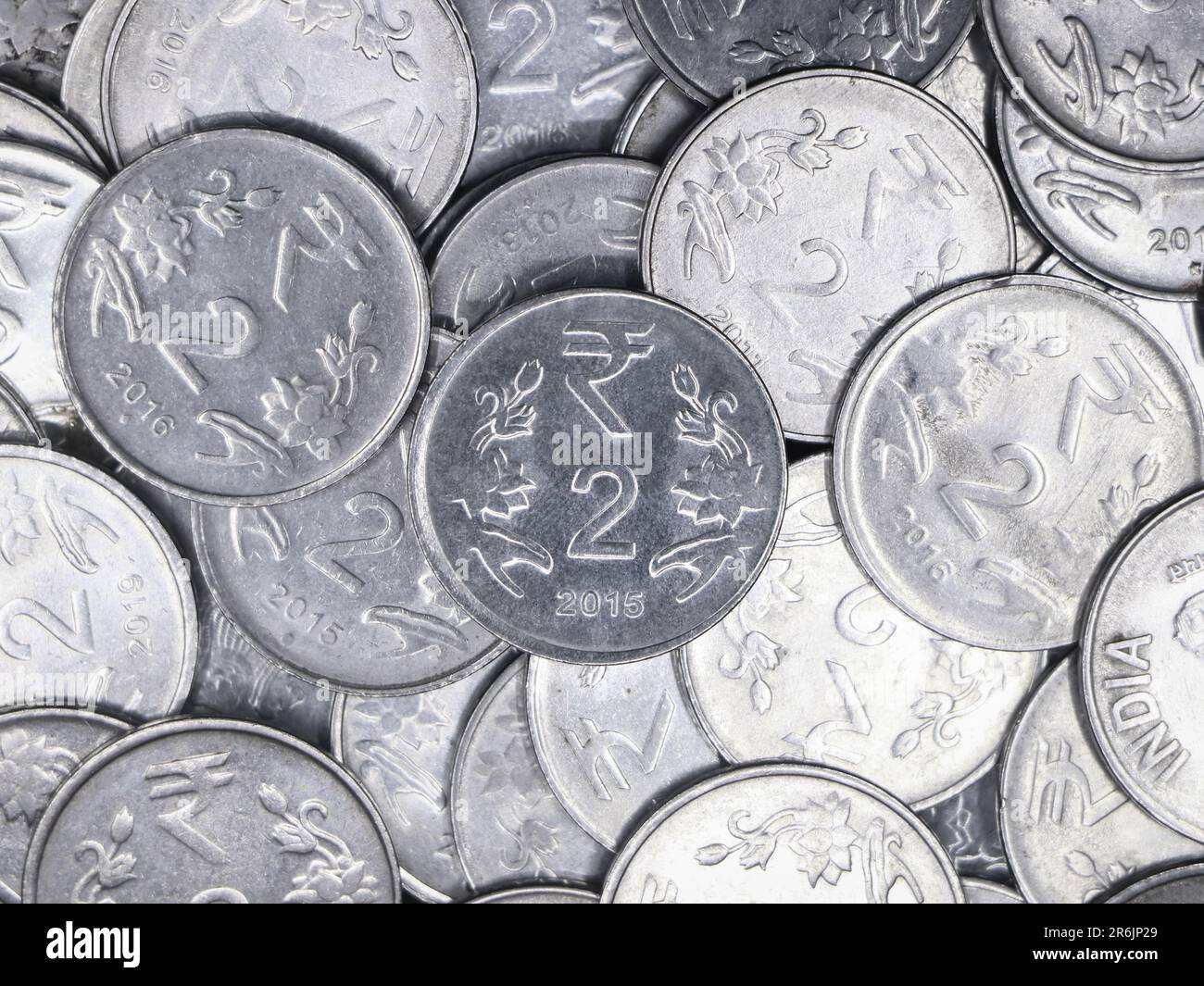 closeup of a collection of indian 2 ( two ) rupee coins made of silver ...
