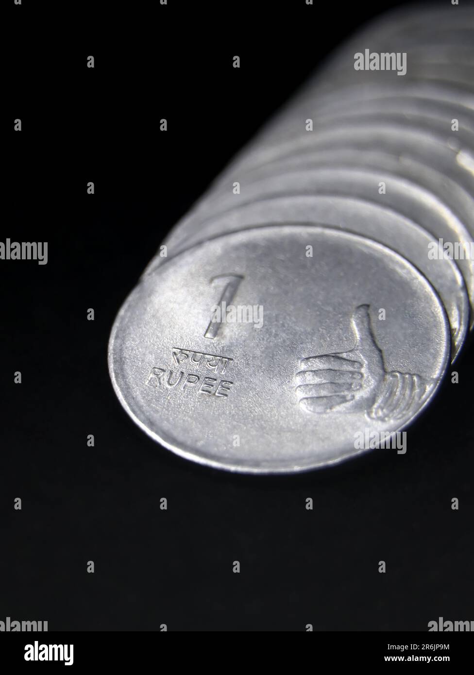closeup of rare vintage indian 1 rupee coin in silver arranged in a row ...