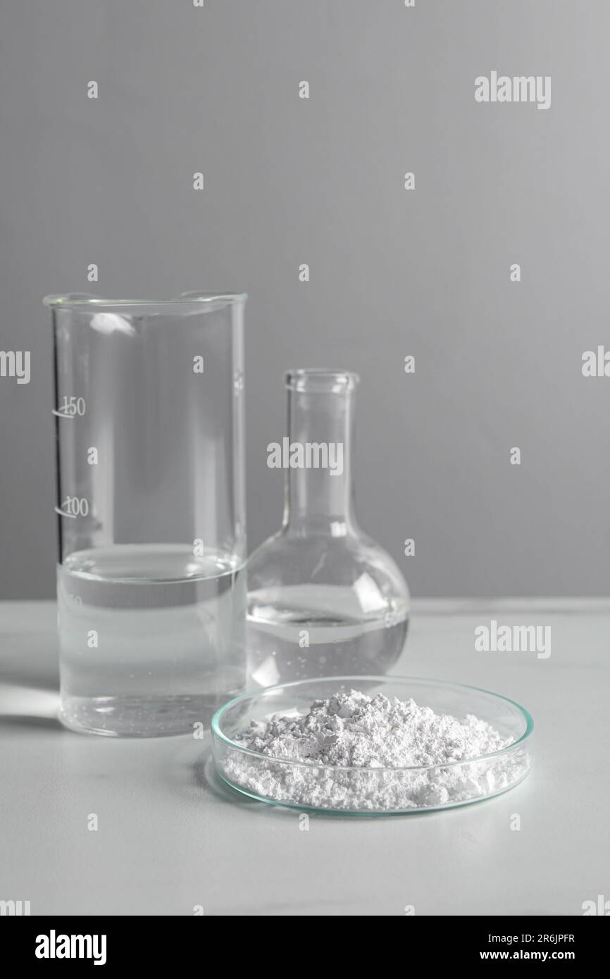 Petri dish with calcium carbonate powder and laboratory glassware on ...